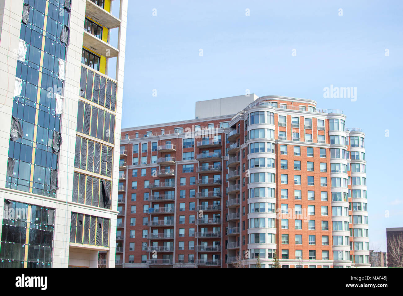 Construction and modern condo buildings with huge windows and balconies ...