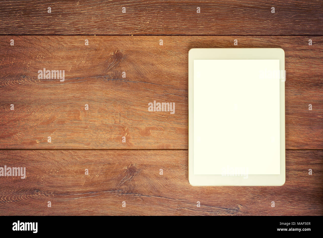 Blank Tablet computer on wood table background with space for text ...