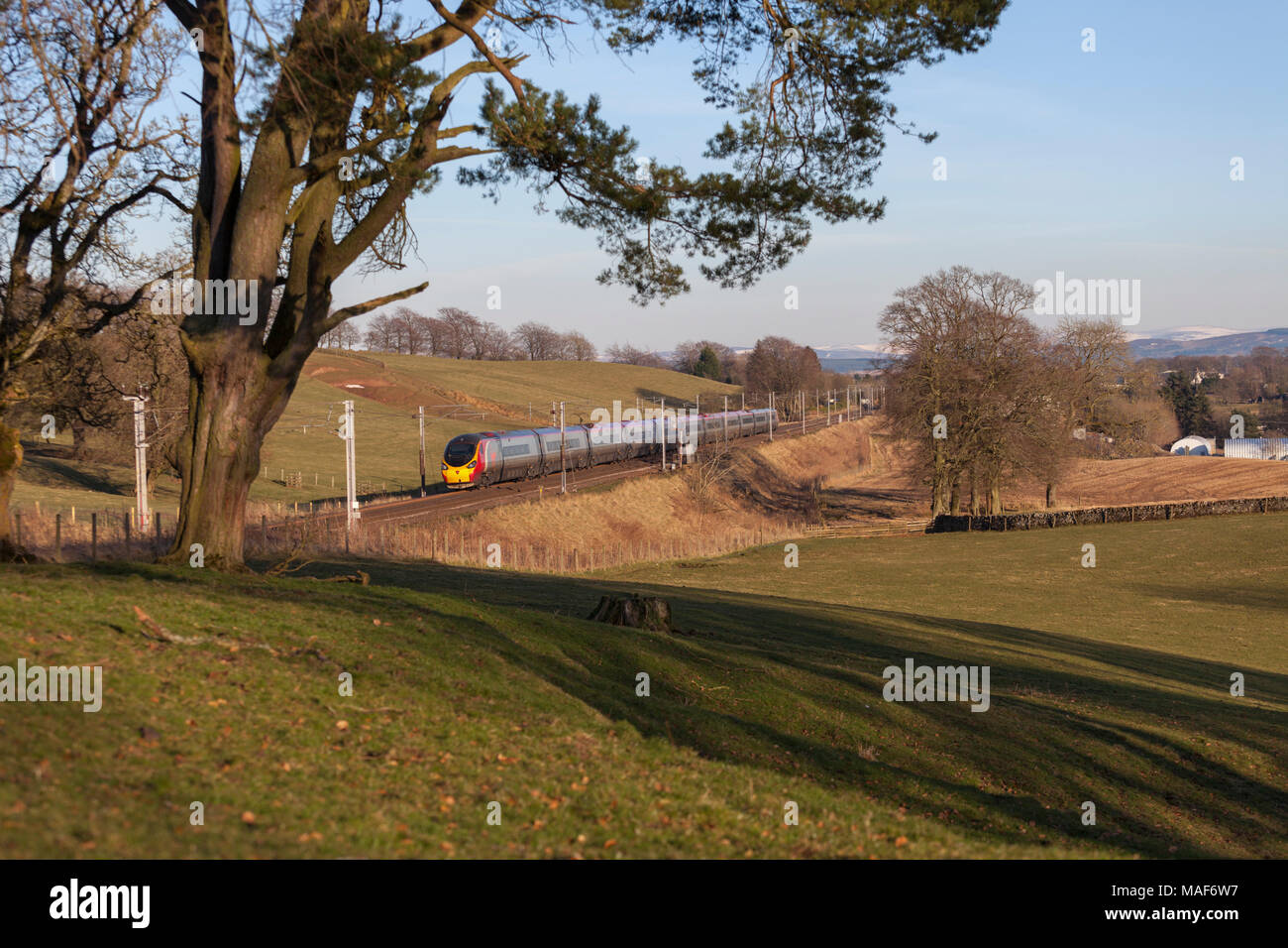 A Virgin trains Pendolino train passes Cleghorn, Lanarkshire on the ...