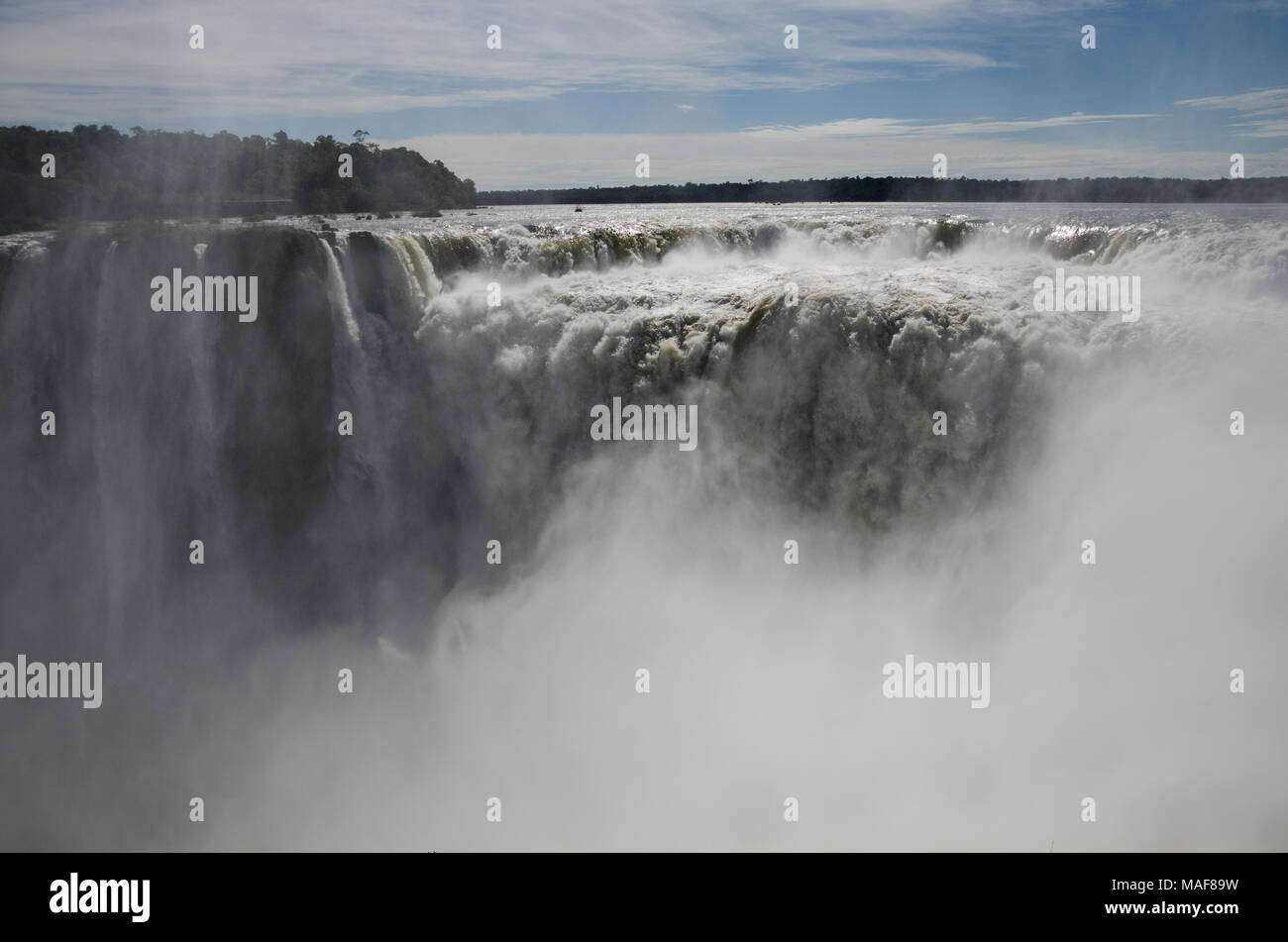 Majestic view of water falling over the top of Iguazu falls. Powerful ...