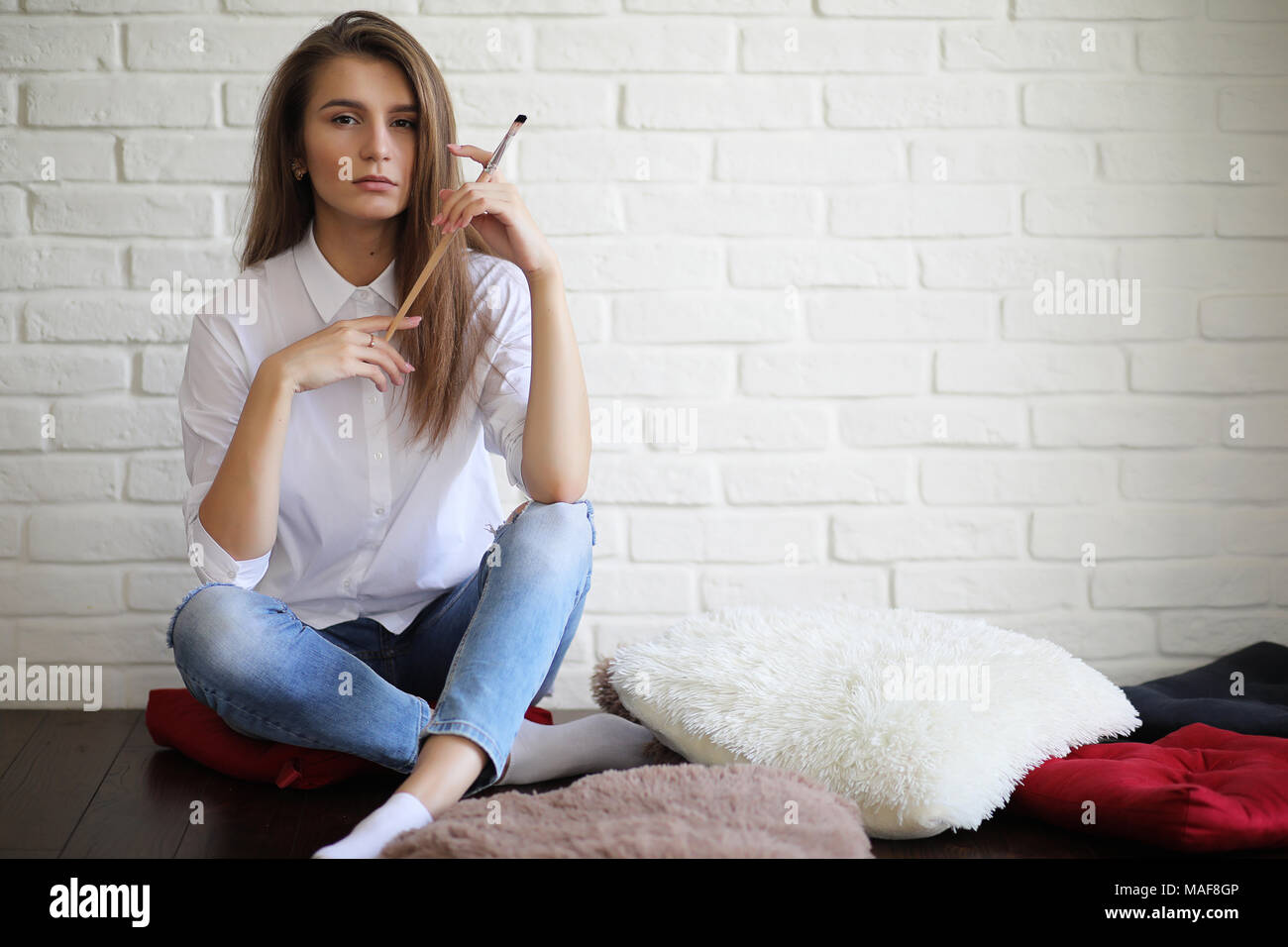 Beautiful girl artist at work in a creative white studio Stock Photo ...