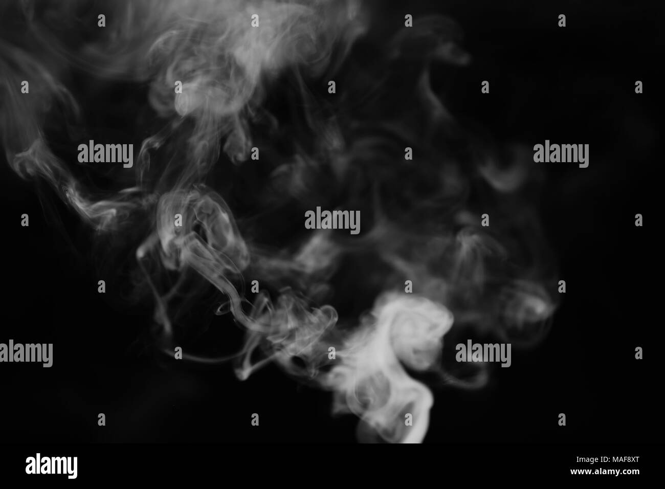 White smoke on a black background. Texture of smoke. Clubs of white ...