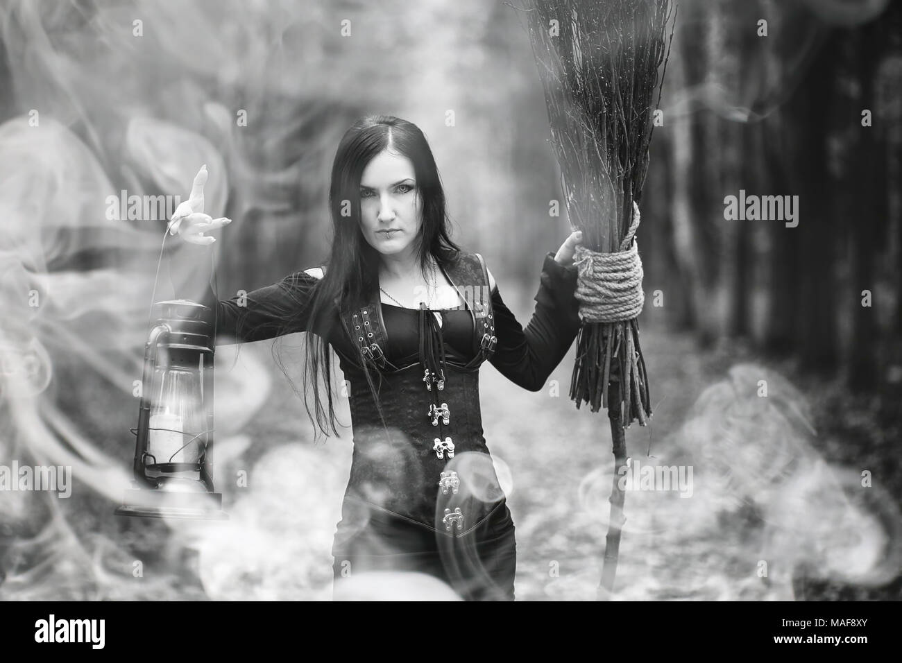 A woman in a witch suit in a dense forest on a ritual Stock Photo - Alamy