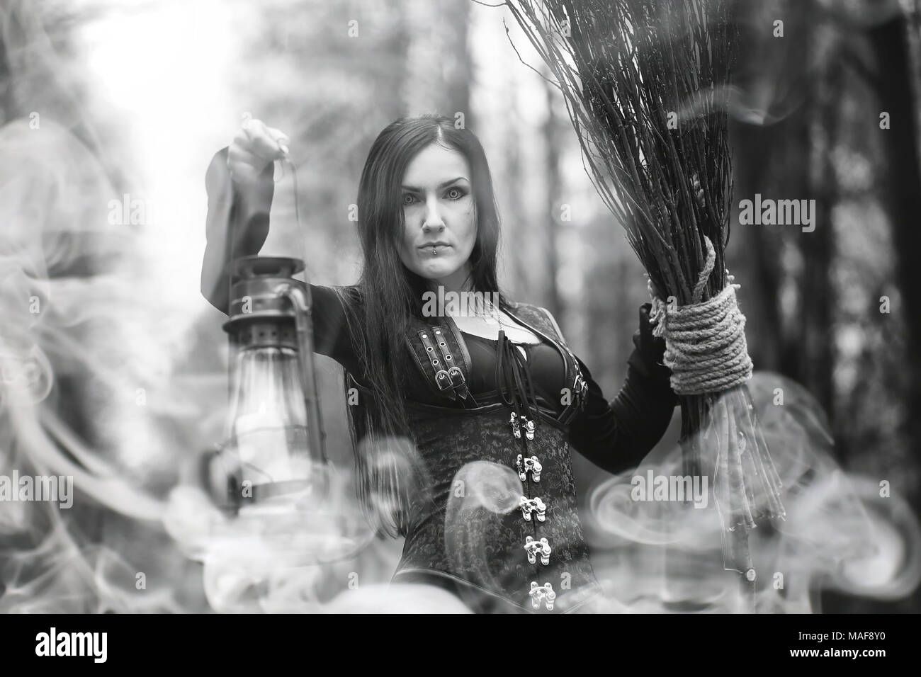 A woman in a witch suit in a dense forest on a ritual Stock Photo - Alamy