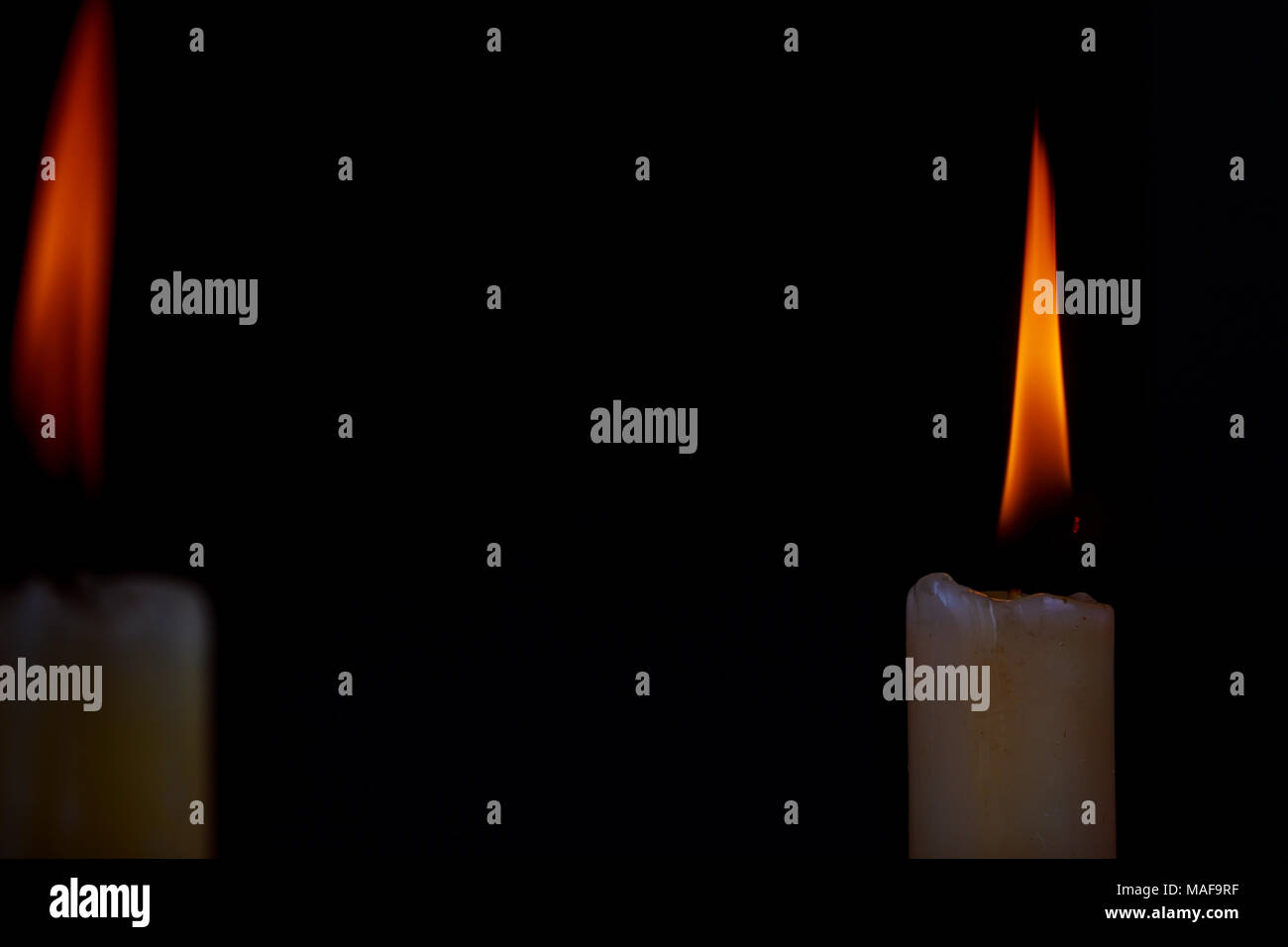 Two candle light memory burning brightly in the black background Stock ...