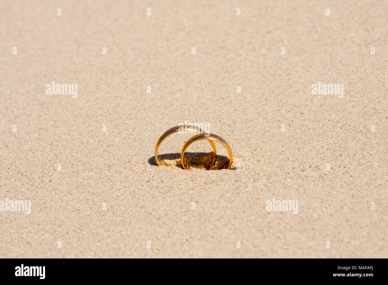Wedding Rings on Beach Stock Photo - Alamy