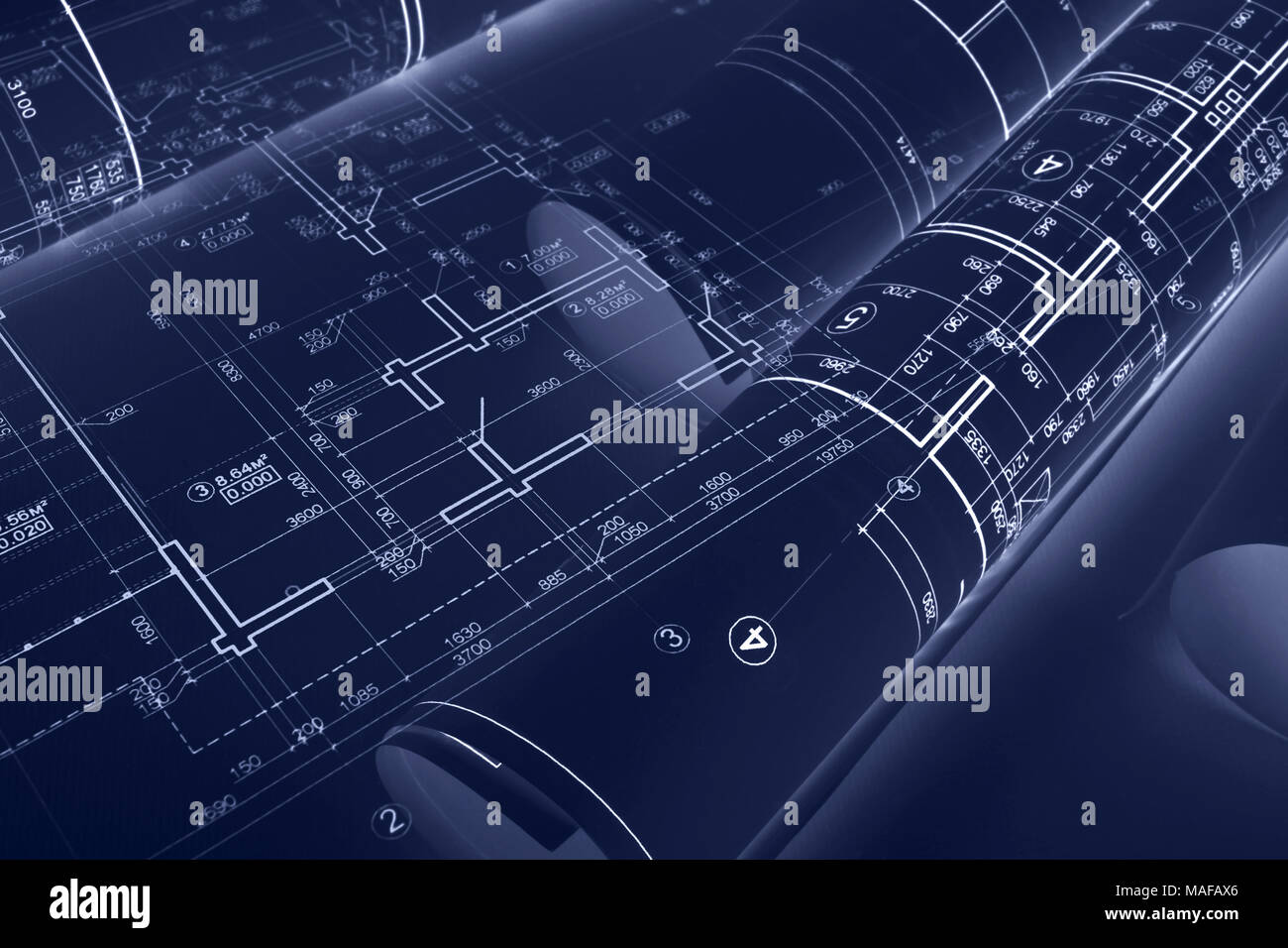 architectural blueprint rolls, technical drawings and sketches on desk ...