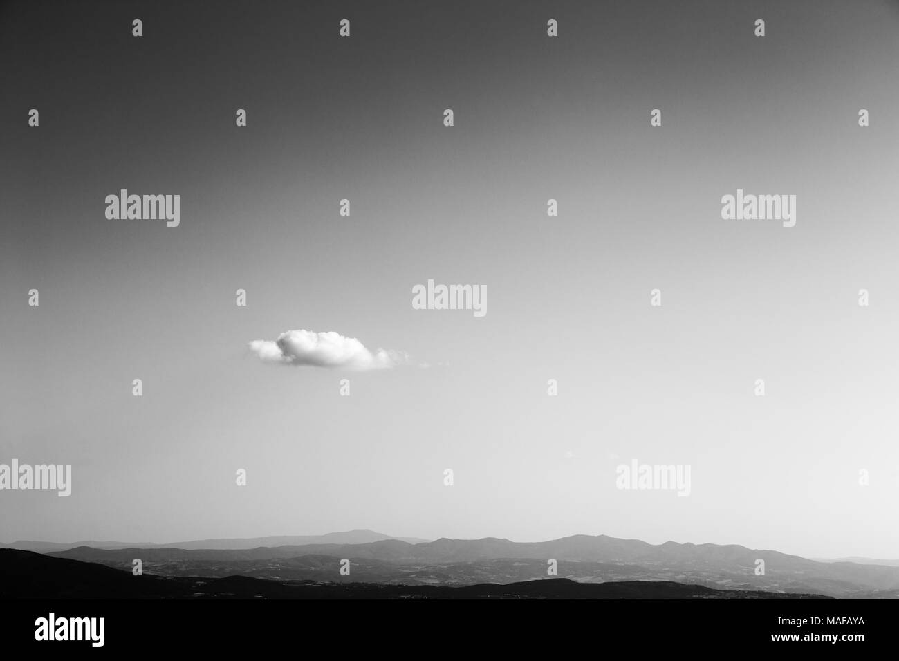 An isolated, little white cloud in an empty sky Stock Photo - Alamy