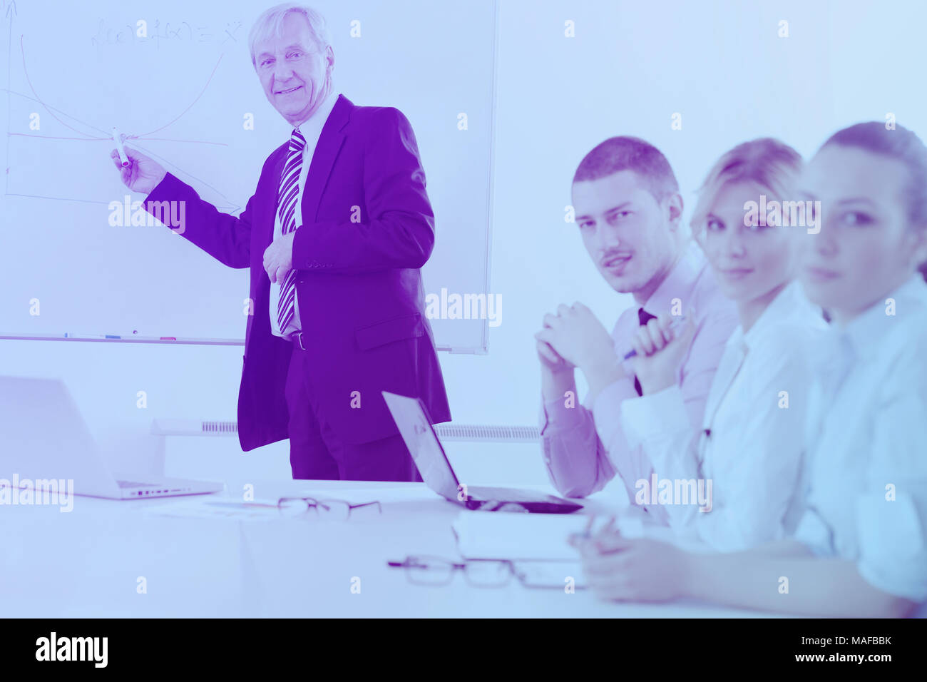 Senior male business man giving a presentation at a meeting at modern ...