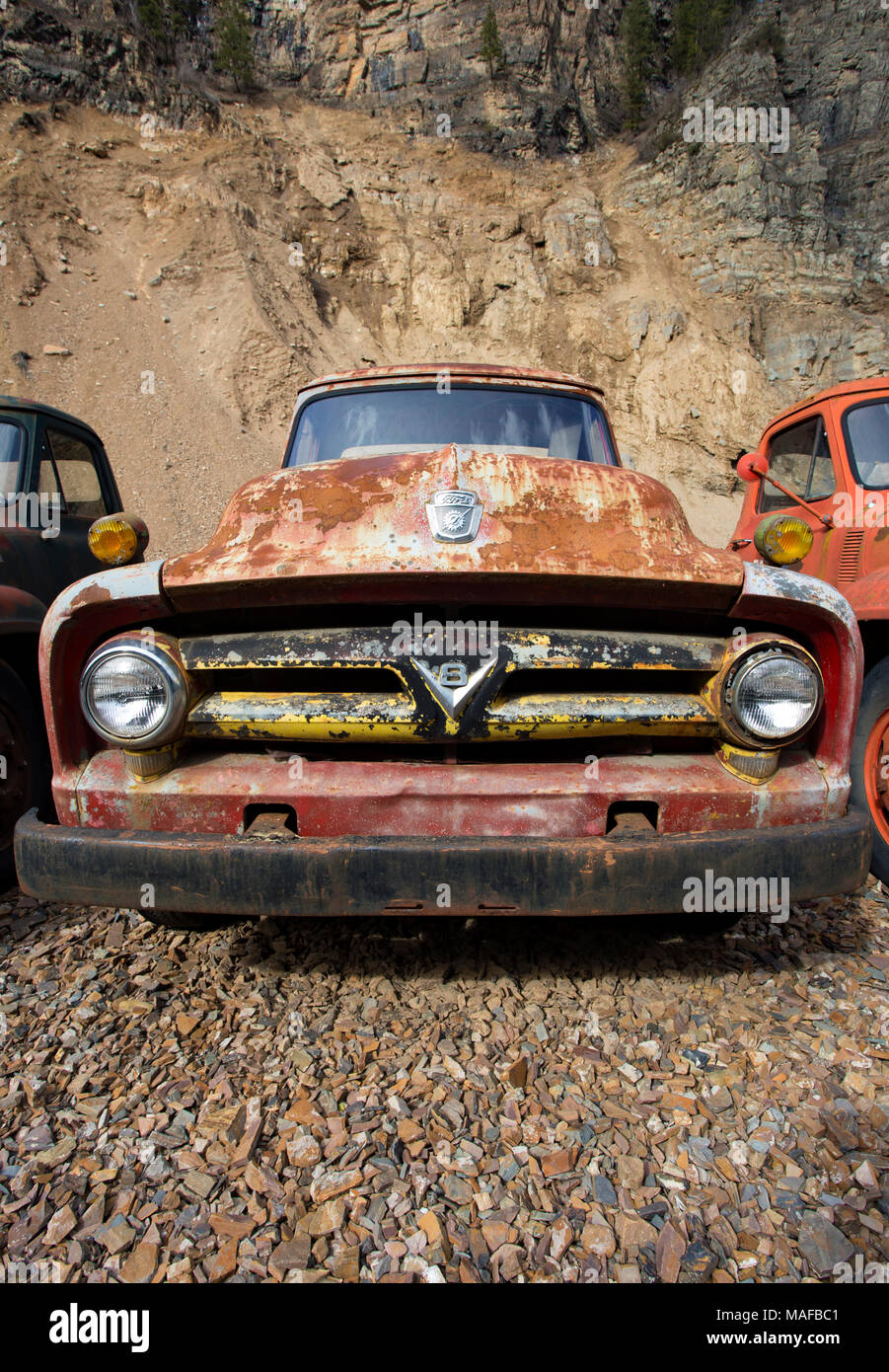 The front of an old, red 1953 Ford F-500 farm truck, in a stone quarry ...