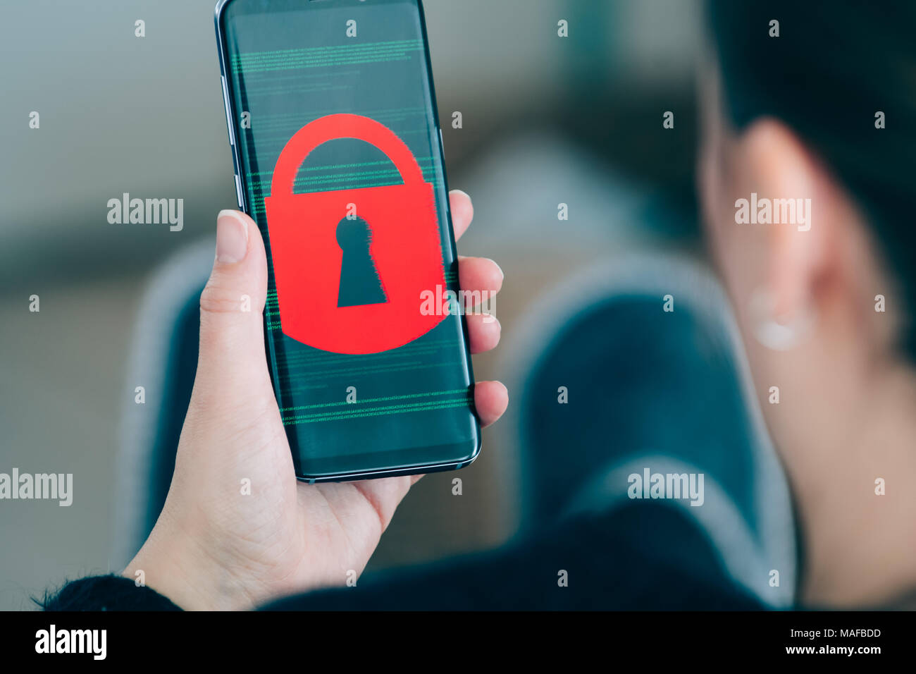 Over the shoulder look of woman holding smart phone device with screen ...