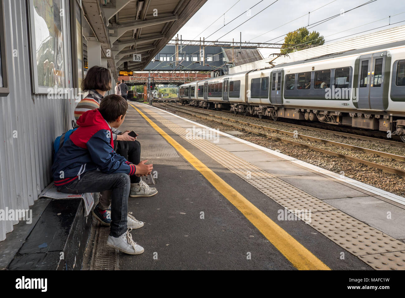 Day view Family of mother and two kids on British railway station ...