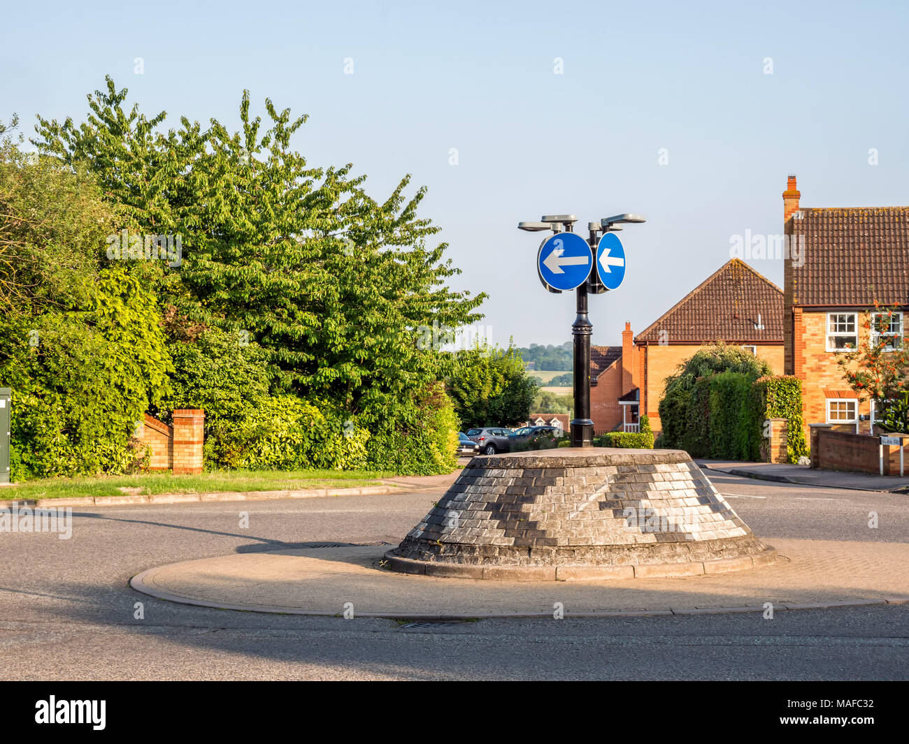 Day view of typical english brick roundabout with directional signs ...