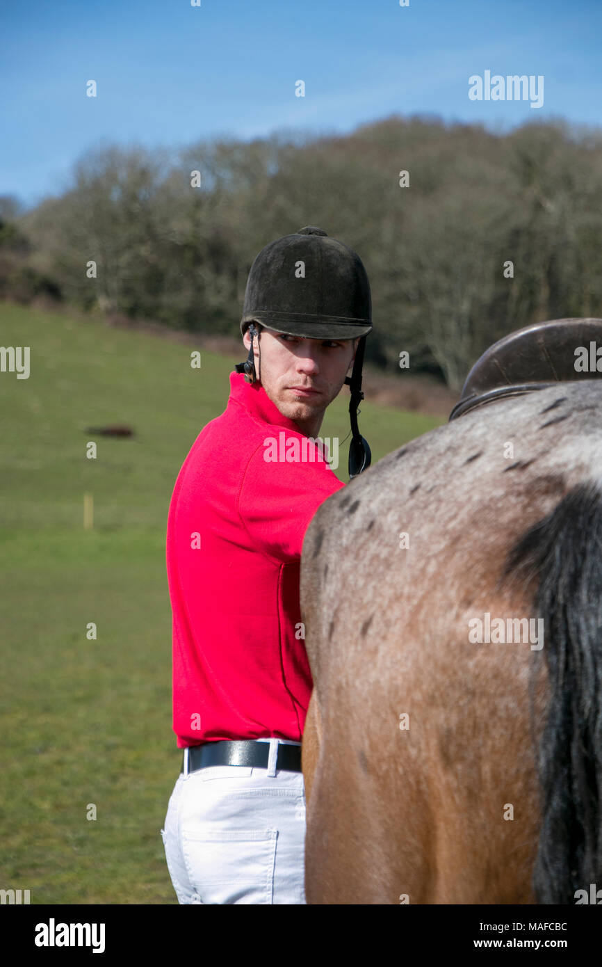 Handsome Male Horse Rider, wearing helmet, Walking beside horse and ...