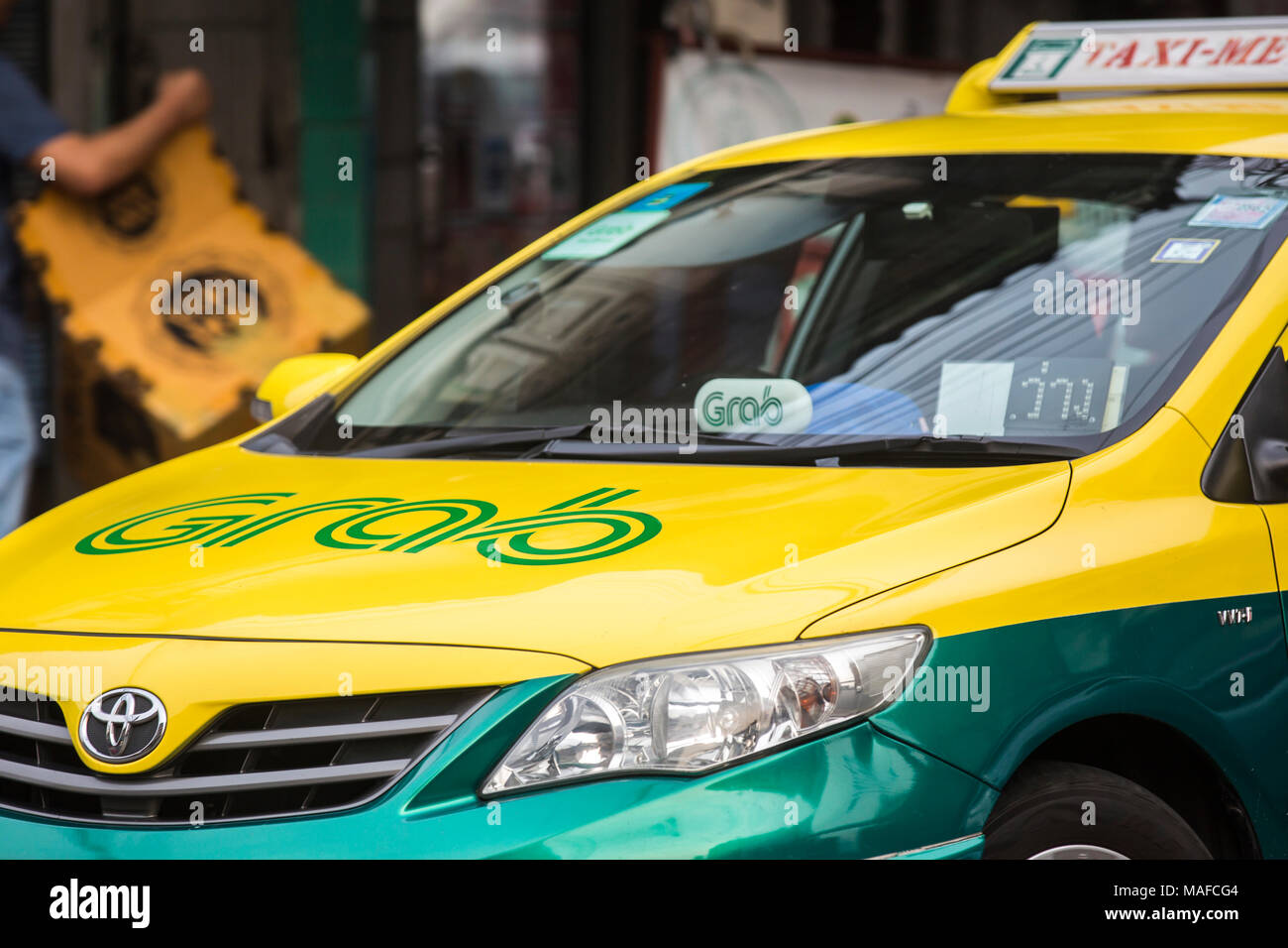 BANGKOK, THAILAND - 27 MARCH, 2018: Grab branded taxi cab on the street ...