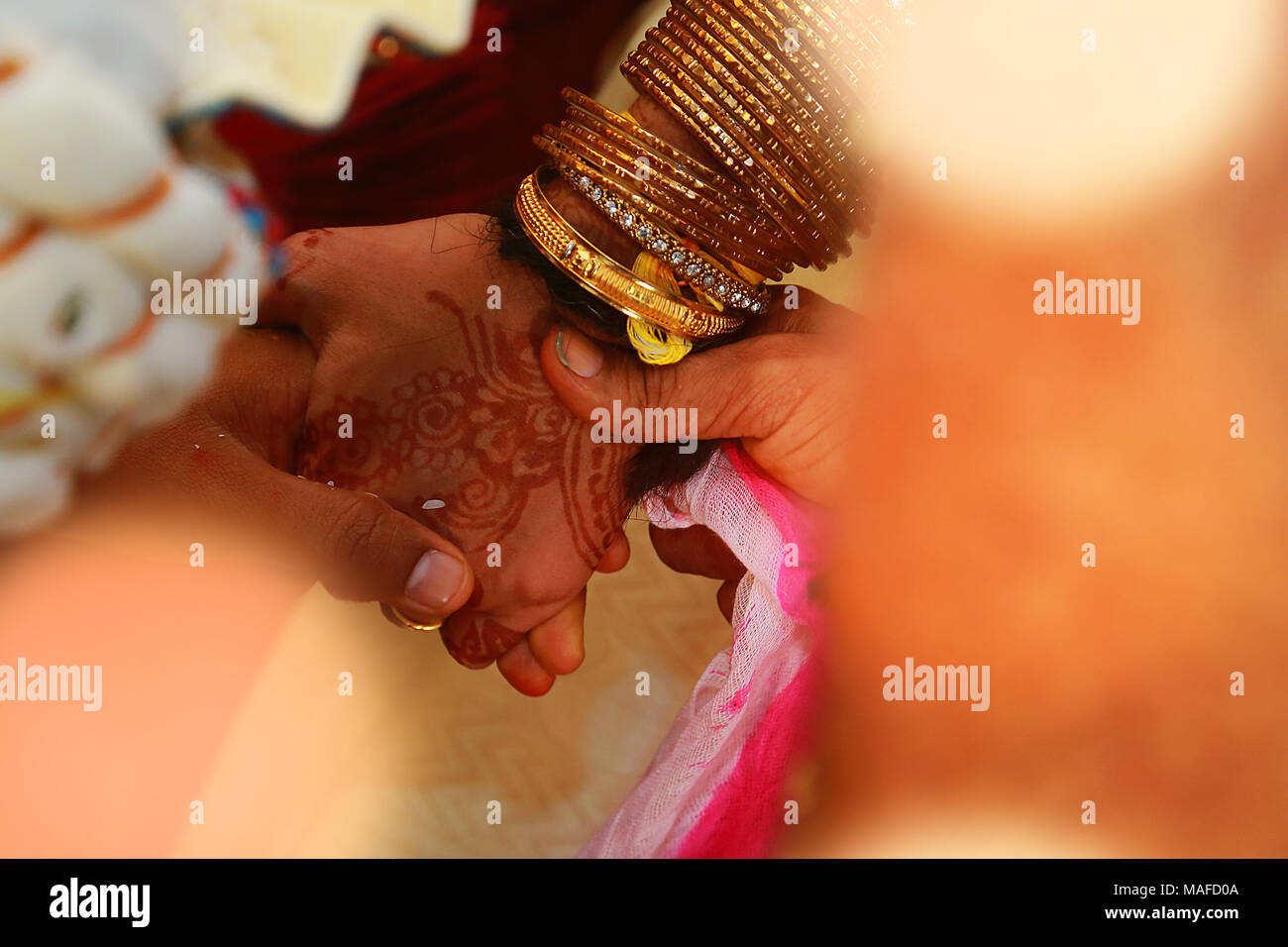 Indian bride and groom holding hands after the wedding Stock Photo - Alamy