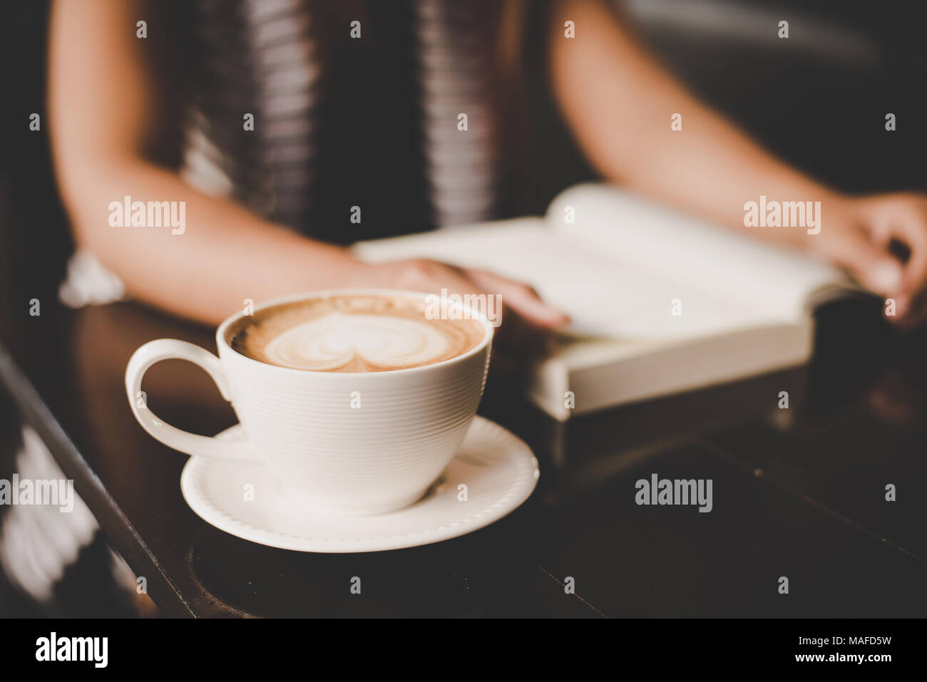 Asian woman relaxing and reading a book in the cafe. Women lifestyle ...