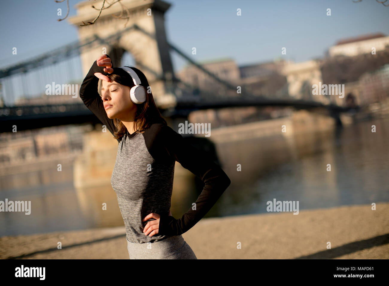 Young female athlete taking break from running workout outdoor Stock ...