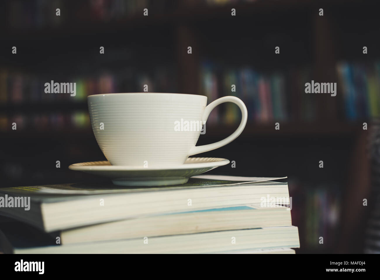 Coffee cup and stack of books on wood table. Education concept Stock ...