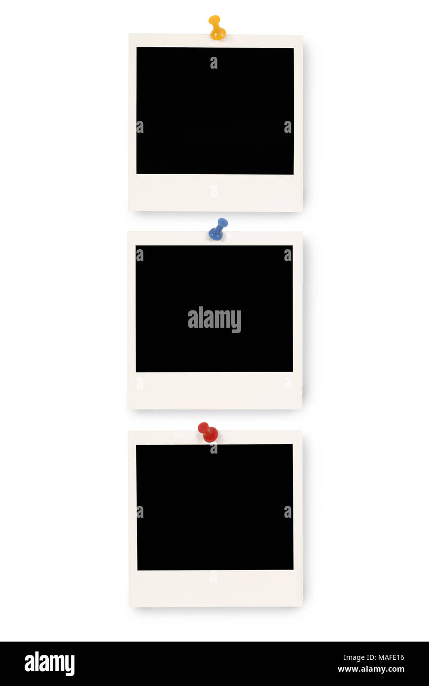 Three blank instant camera photo prints with blue and red pushpins ...