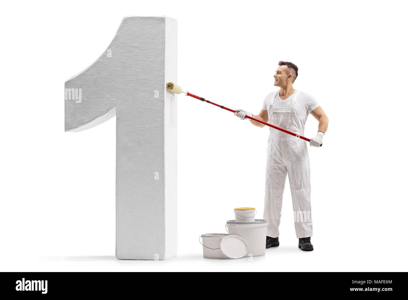 Full length profile shot of a painter painting a number one figure ...
