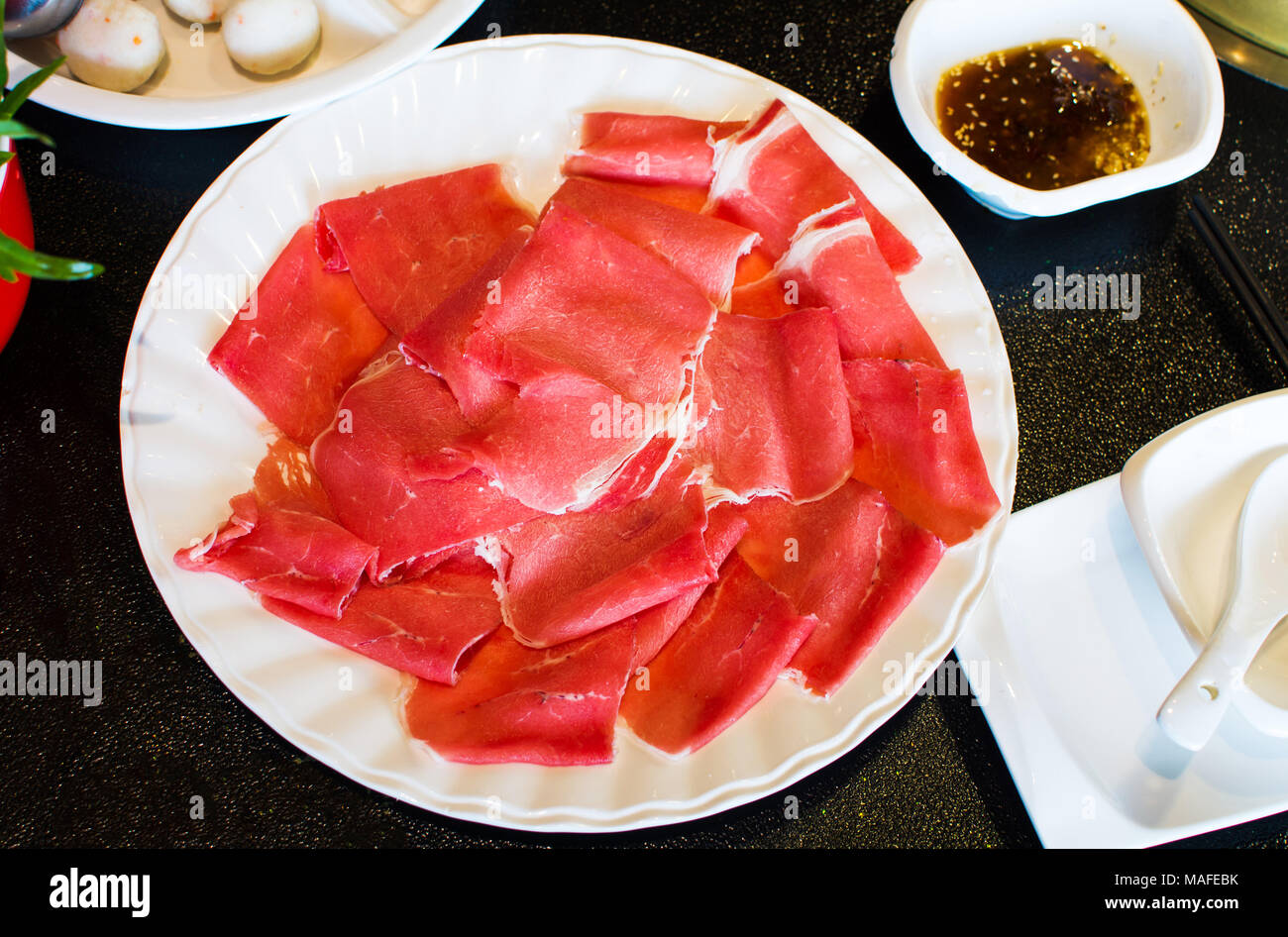 Sliced meat on a plate ready for hotpot meal Stock Photo - Alamy