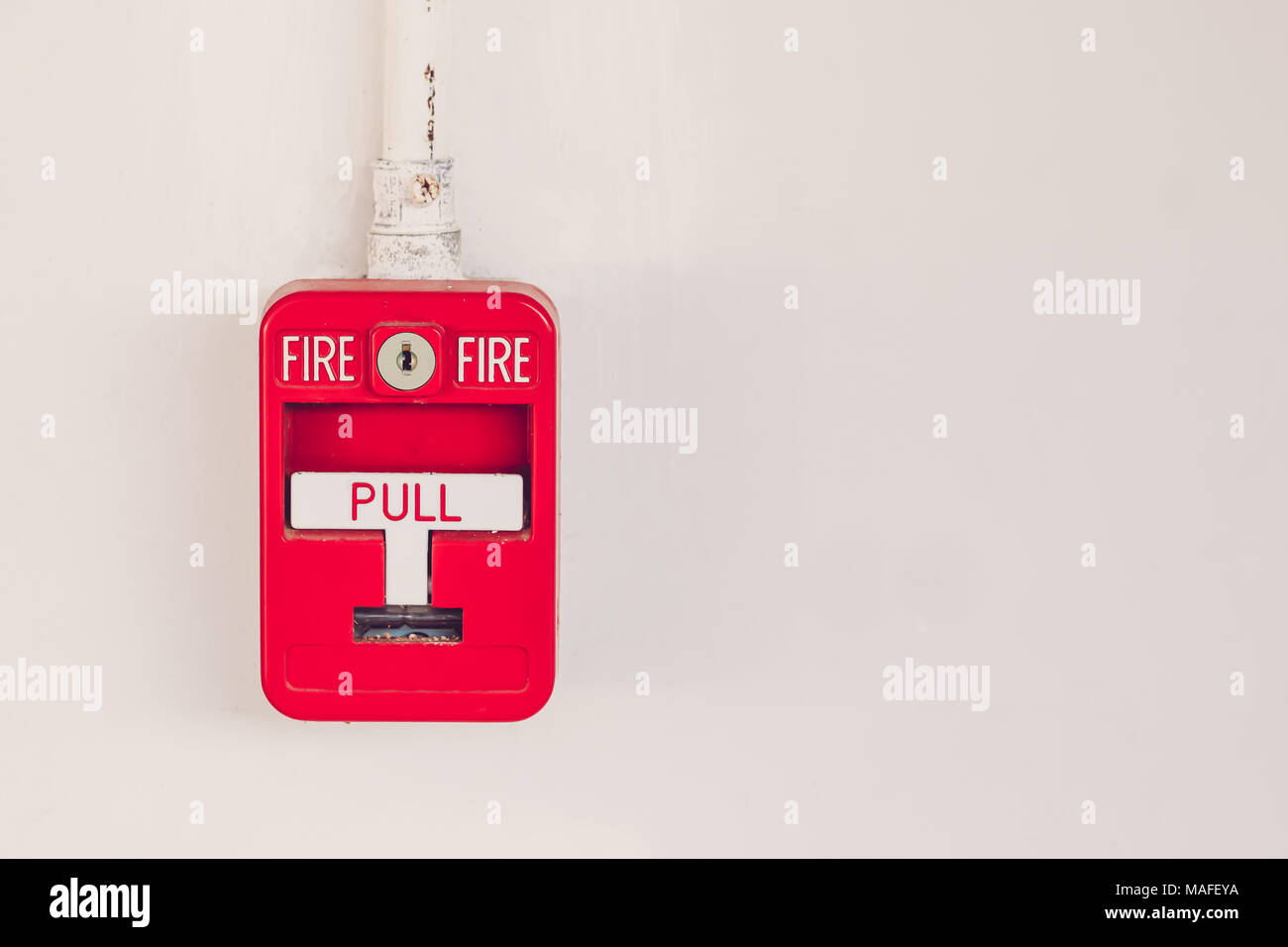 Old red box fire alarm isolated on white background Stock Photo - Alamy