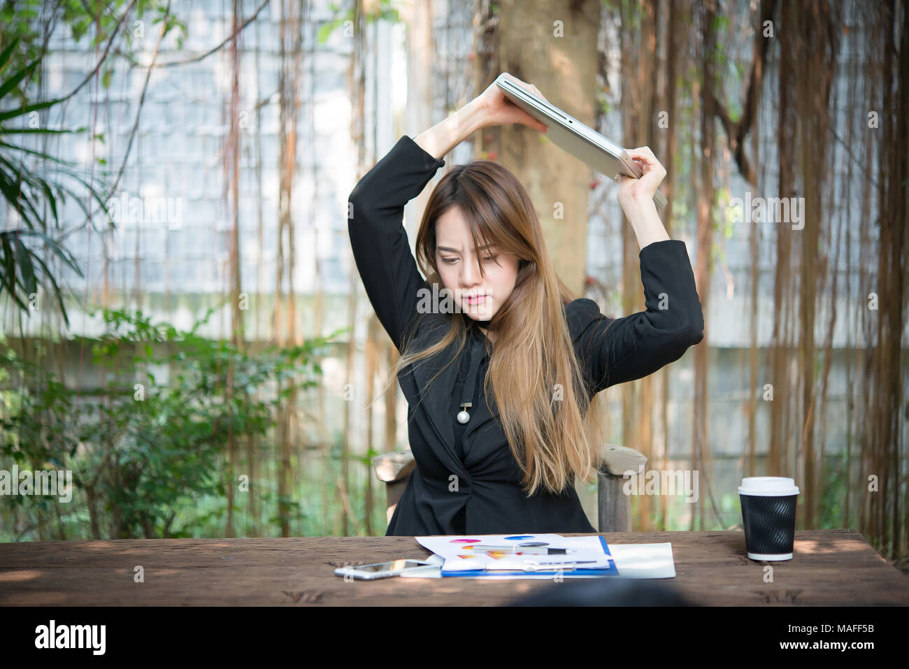 Business Woman getting crazy with of her laptop Stock Photo - Alamy