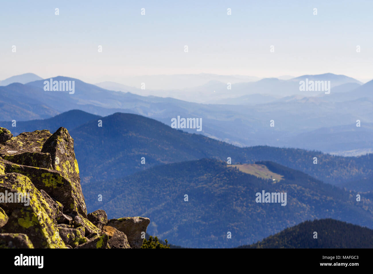 Stack of stones covered with moss on top of a mountain on mountains ...