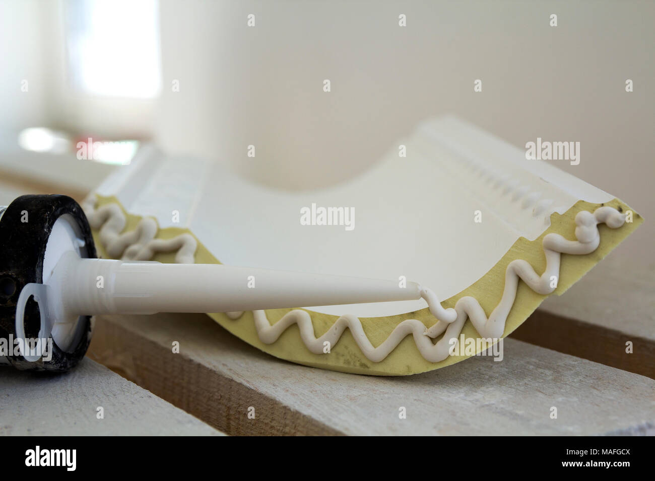 Close-up detail of decoration molding with glue adhesive before ...