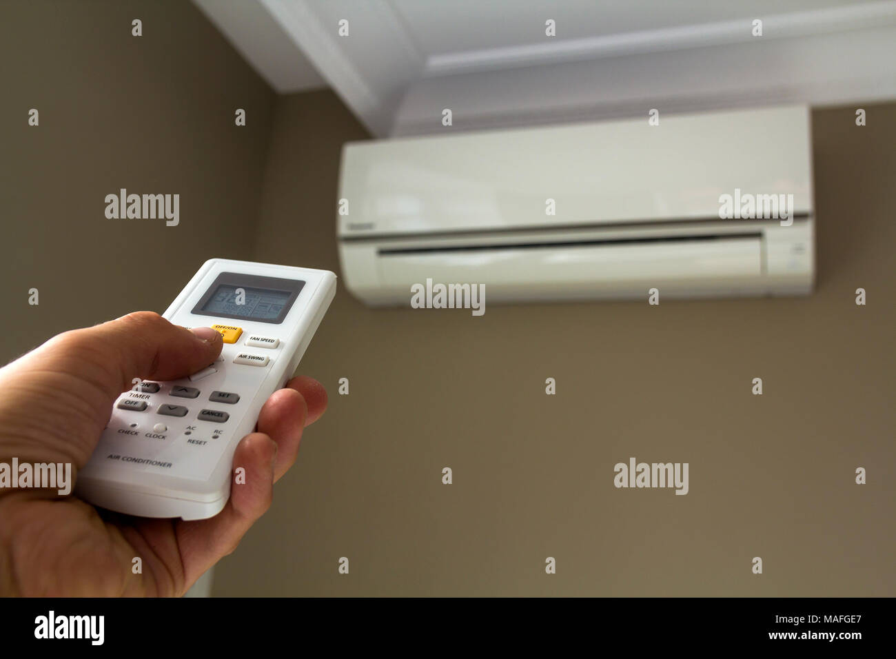Hand holdind control switch of home air conditioner Stock Photo - Alamy