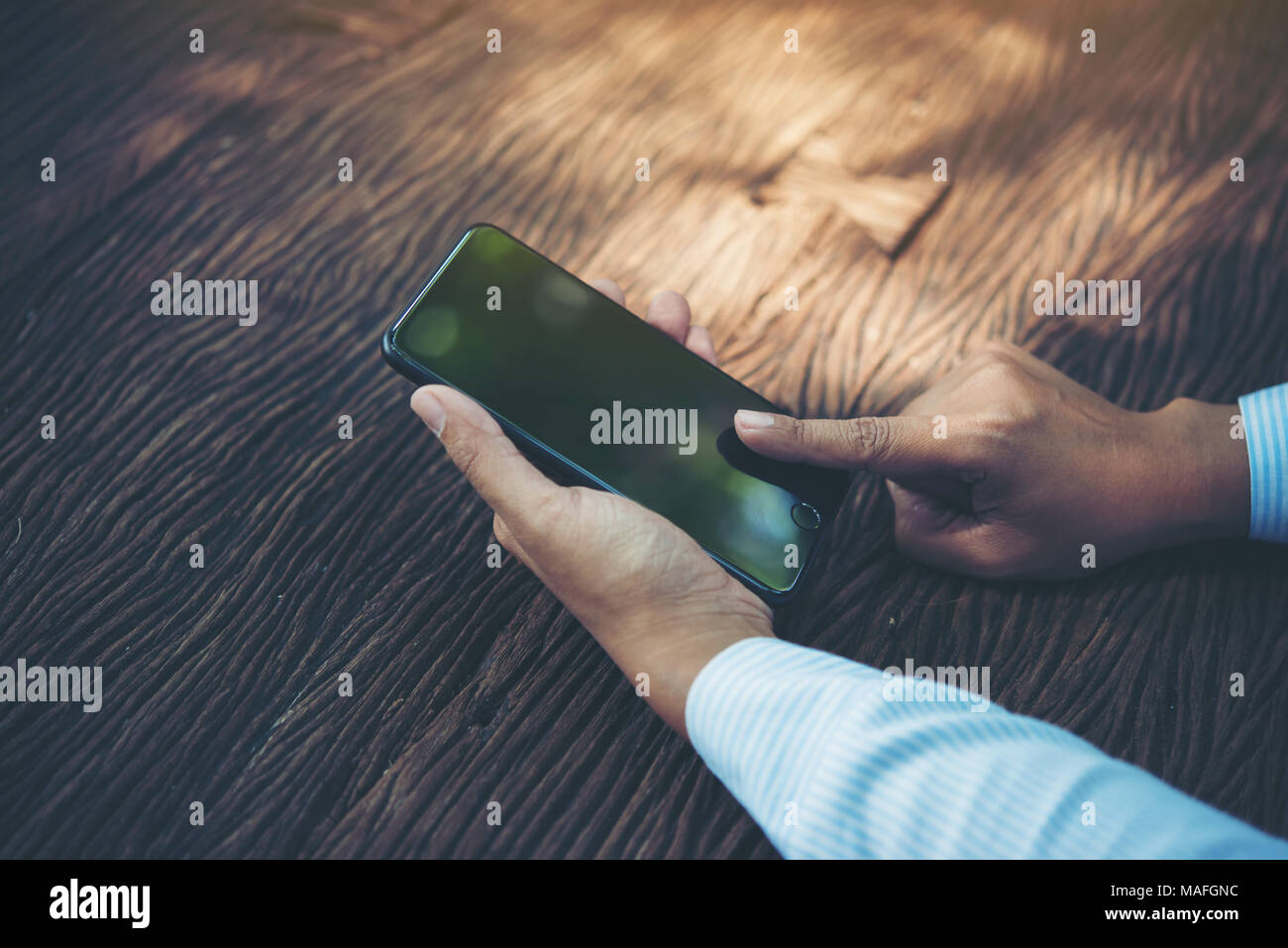 hand holding smart phone and play something Stock Photo - Alamy