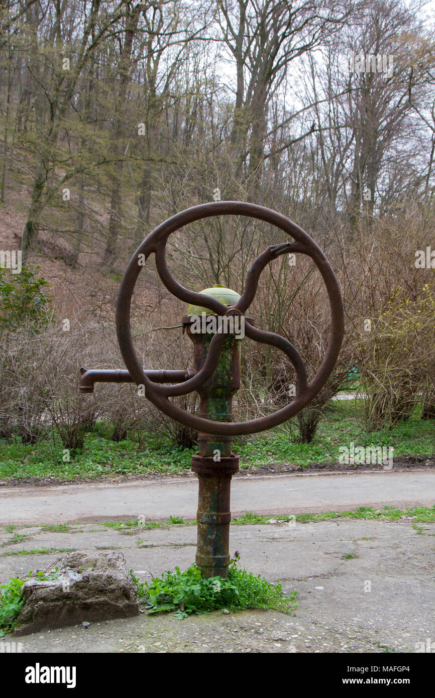 Old village well with wheel. Old metal well construction Stock Photo ...