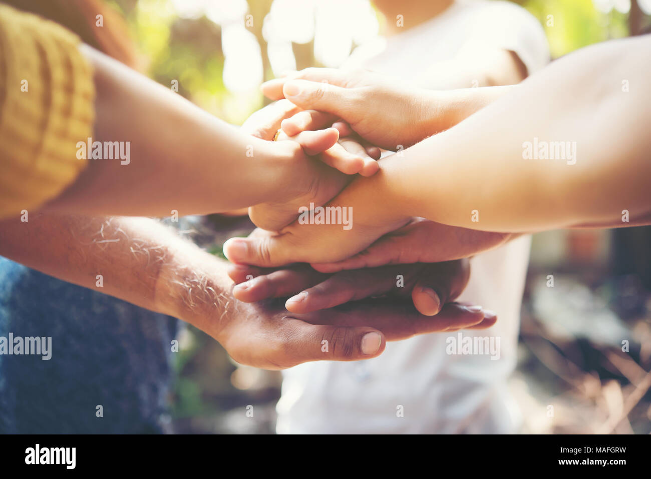Close up of young people putting their hands together. Team with stack ...