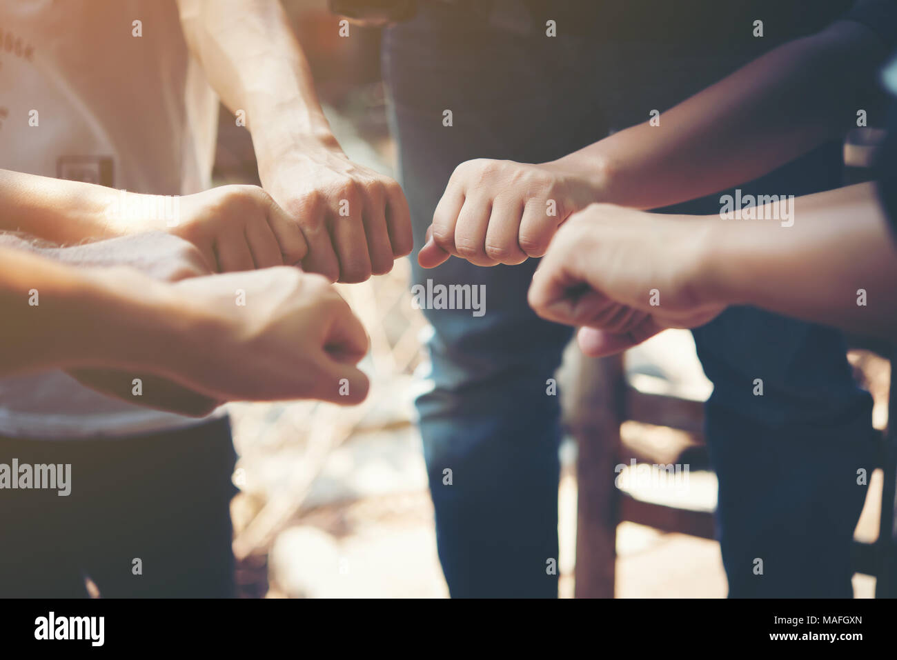 Close up of young people putting their hands together. Team with stack ...