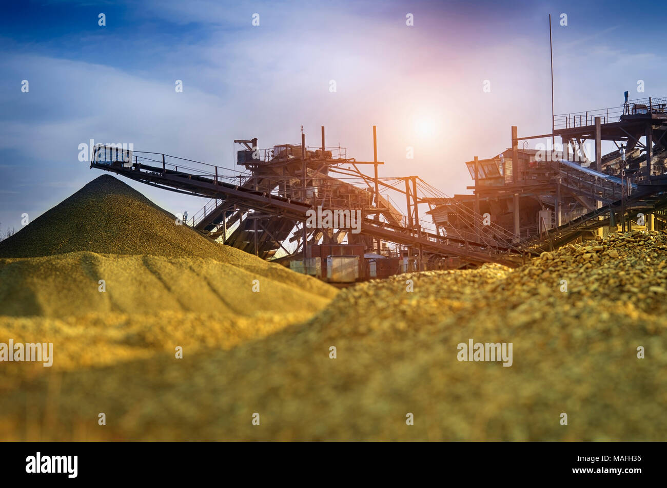 conveyors in a stone quarry at sunset Stock Photo - Alamy