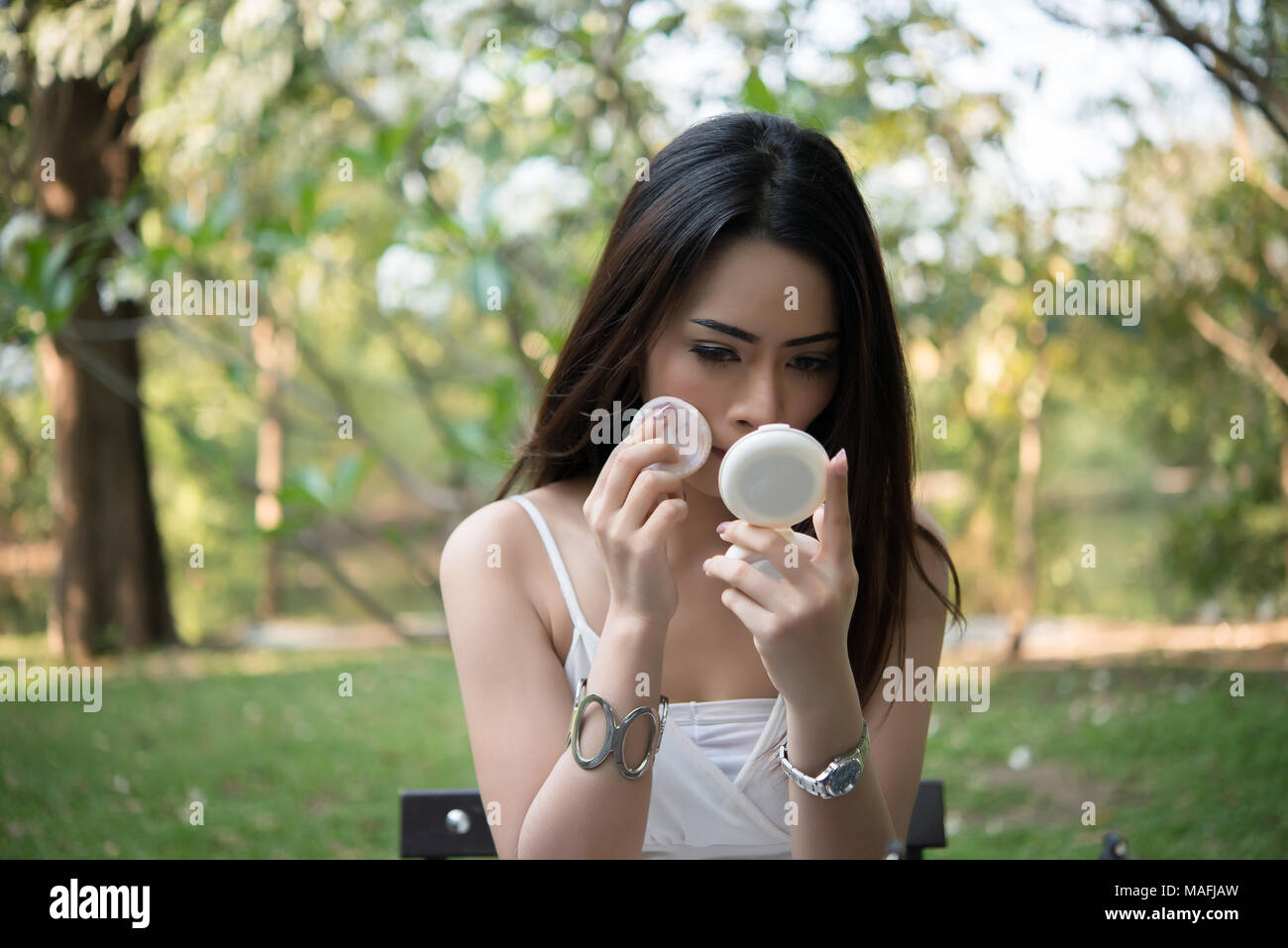 Portrait of beautiful young woman causes powder to face Stock Photo - Alamy