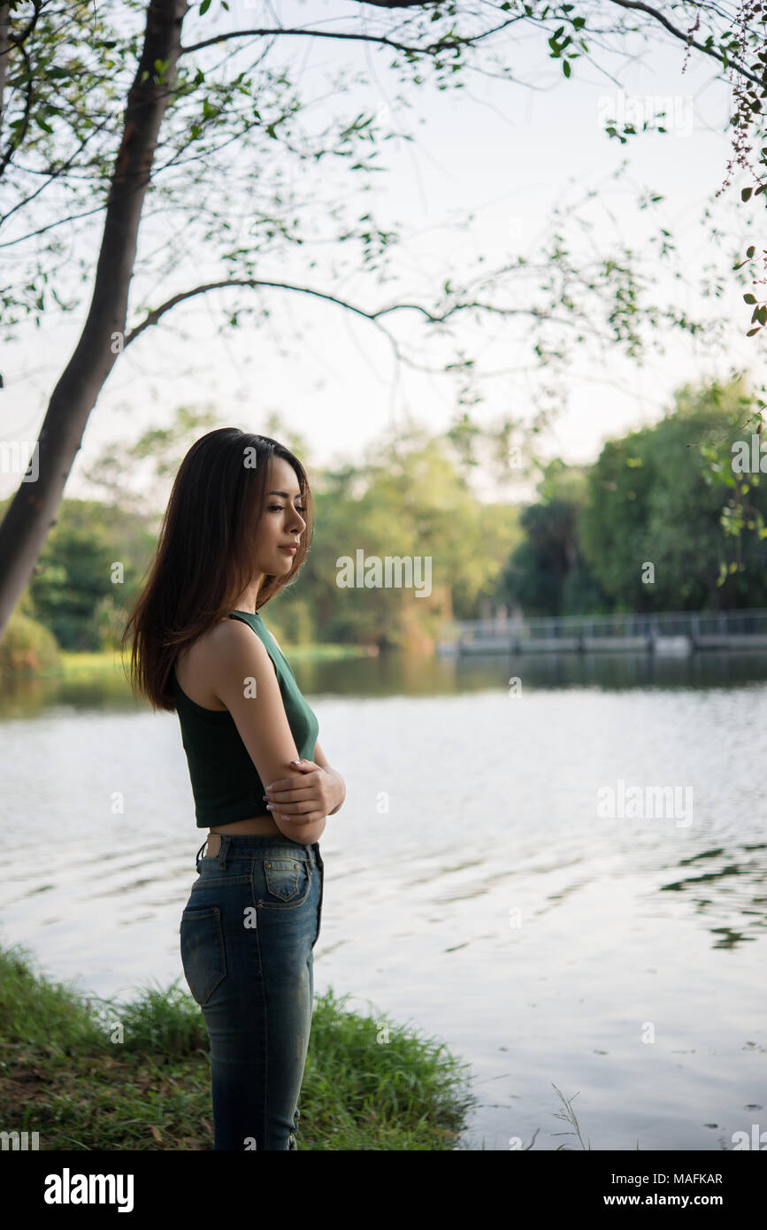 Young pretty girl was sad standing in the park she was disappointed and ...