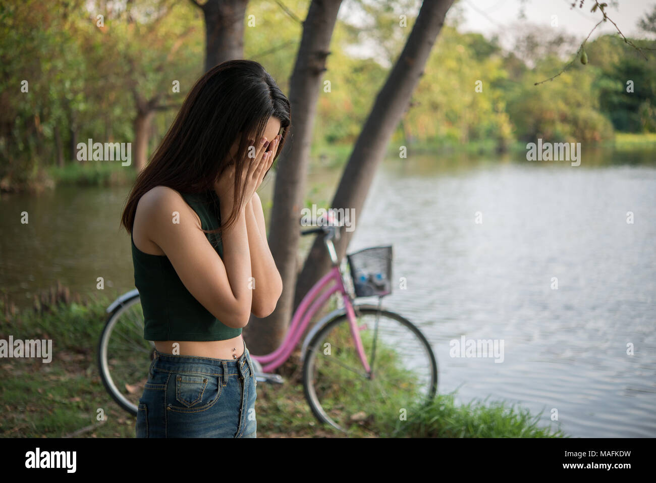Young pretty girl was sad standing in the park she was disappointed ...