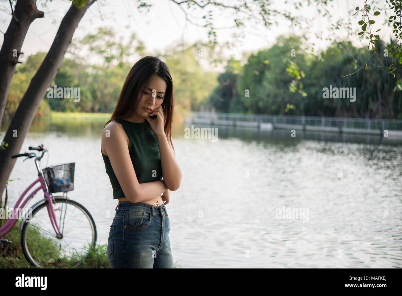 Young pretty girl was sad standing in the park she was disappointed ...