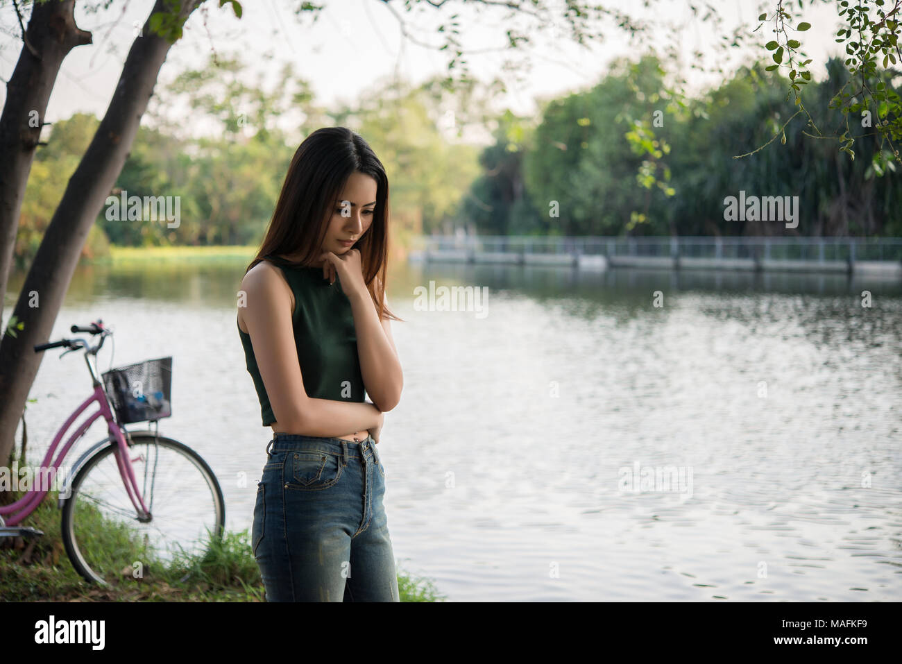 Young pretty girl was sad standing in the park she was disappointed ...