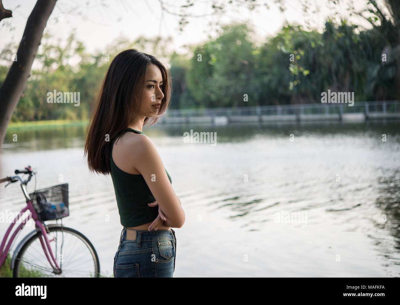 Young pretty girl was sad standing in the park she was disappointed and ...