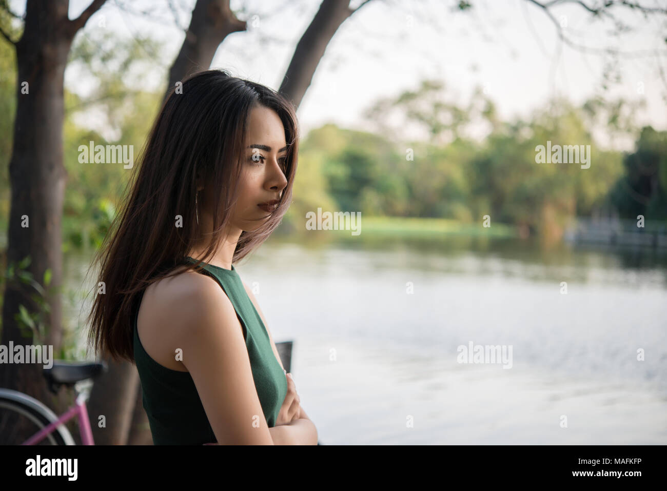 Young pretty girl was sad standing in the park she was disappointed and ...
