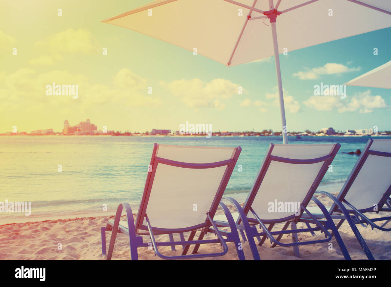 Deck chair on a beautiful beach during sunrise Stock Photo - Alamy
