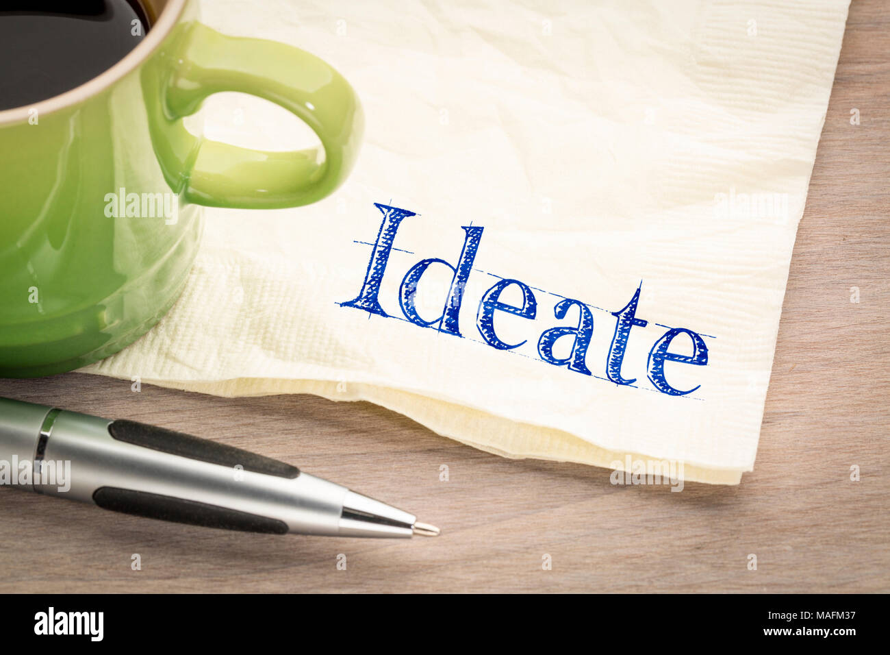 Ideate - form ideas, handwriting on napkin with a cup of tea Stock ...