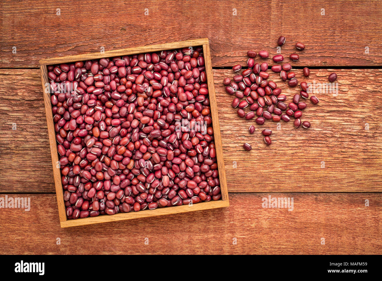 Japanese adzuki (aduki, azuki) beans in a wooden box against rustic ...
