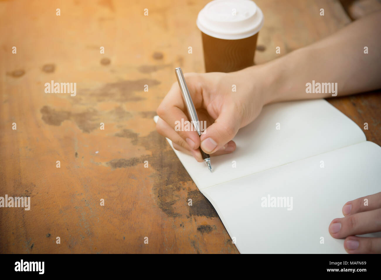 Man Hand write on the notebook Stock Photo - Alamy