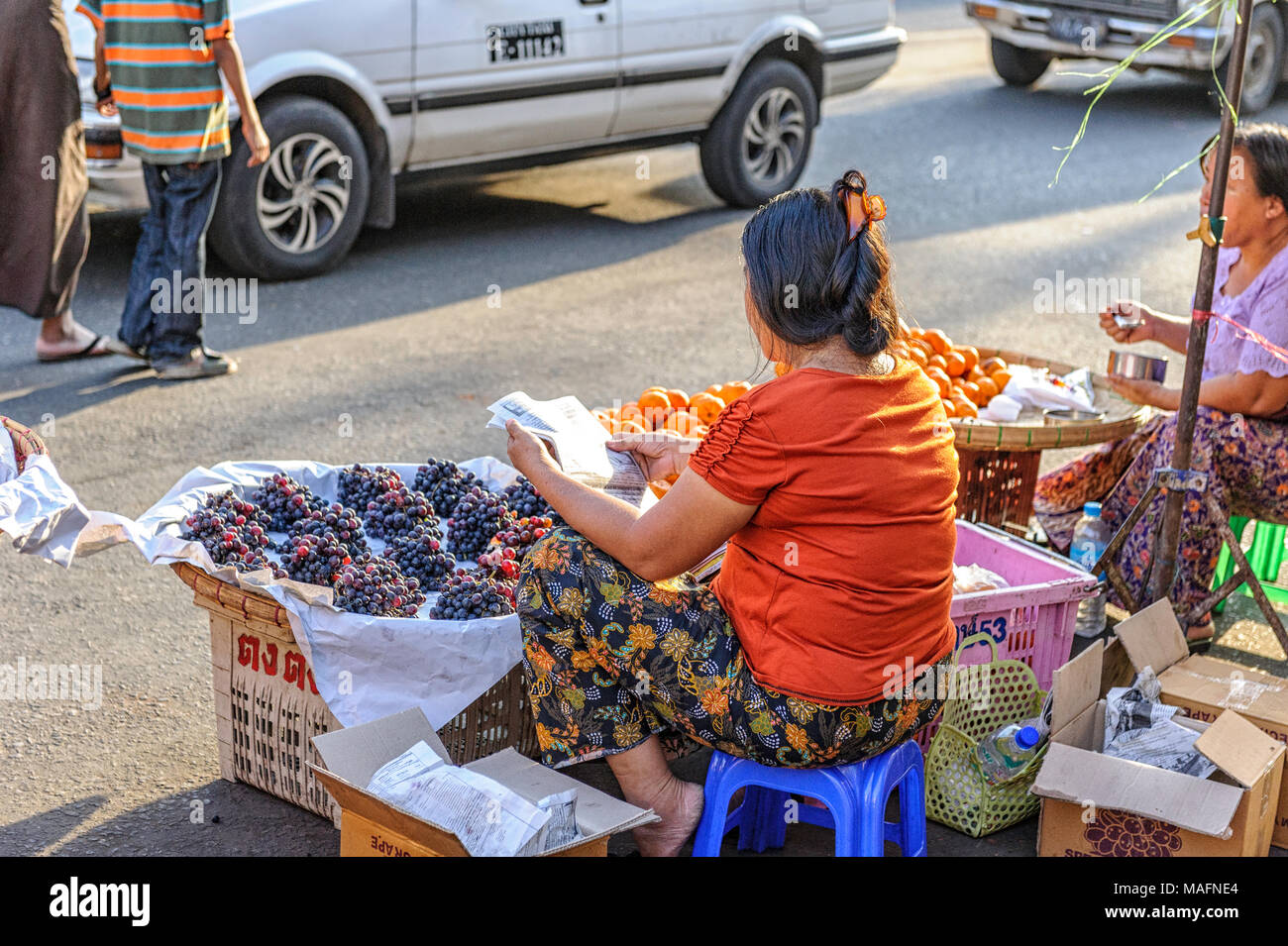 Woman selling grapes on the street in Yangon, Myanmar Stock Photo - Alamy