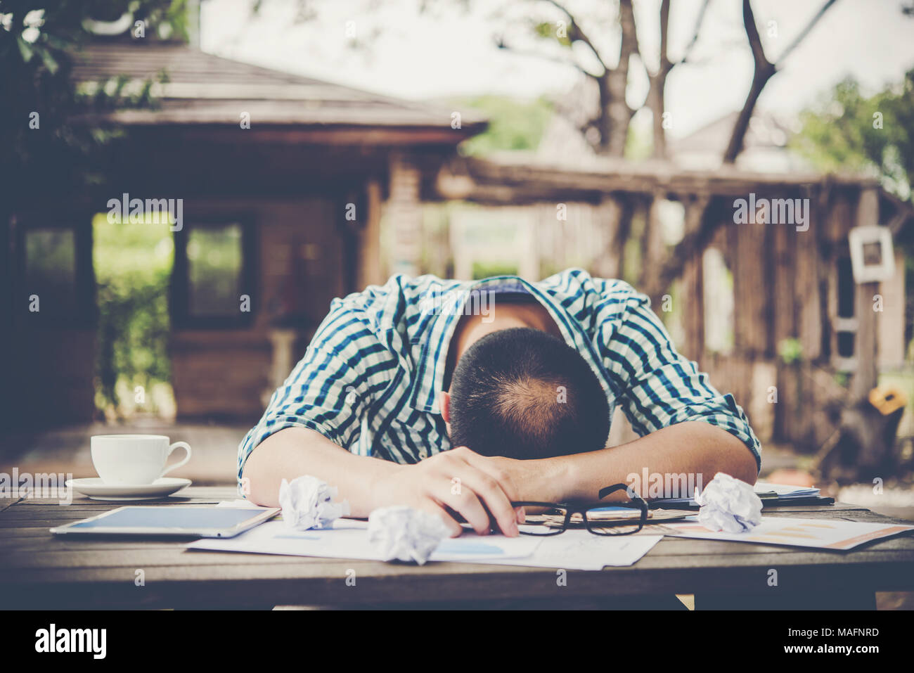 Tired working man sleeping at the workplace full of work Stock Photo ...