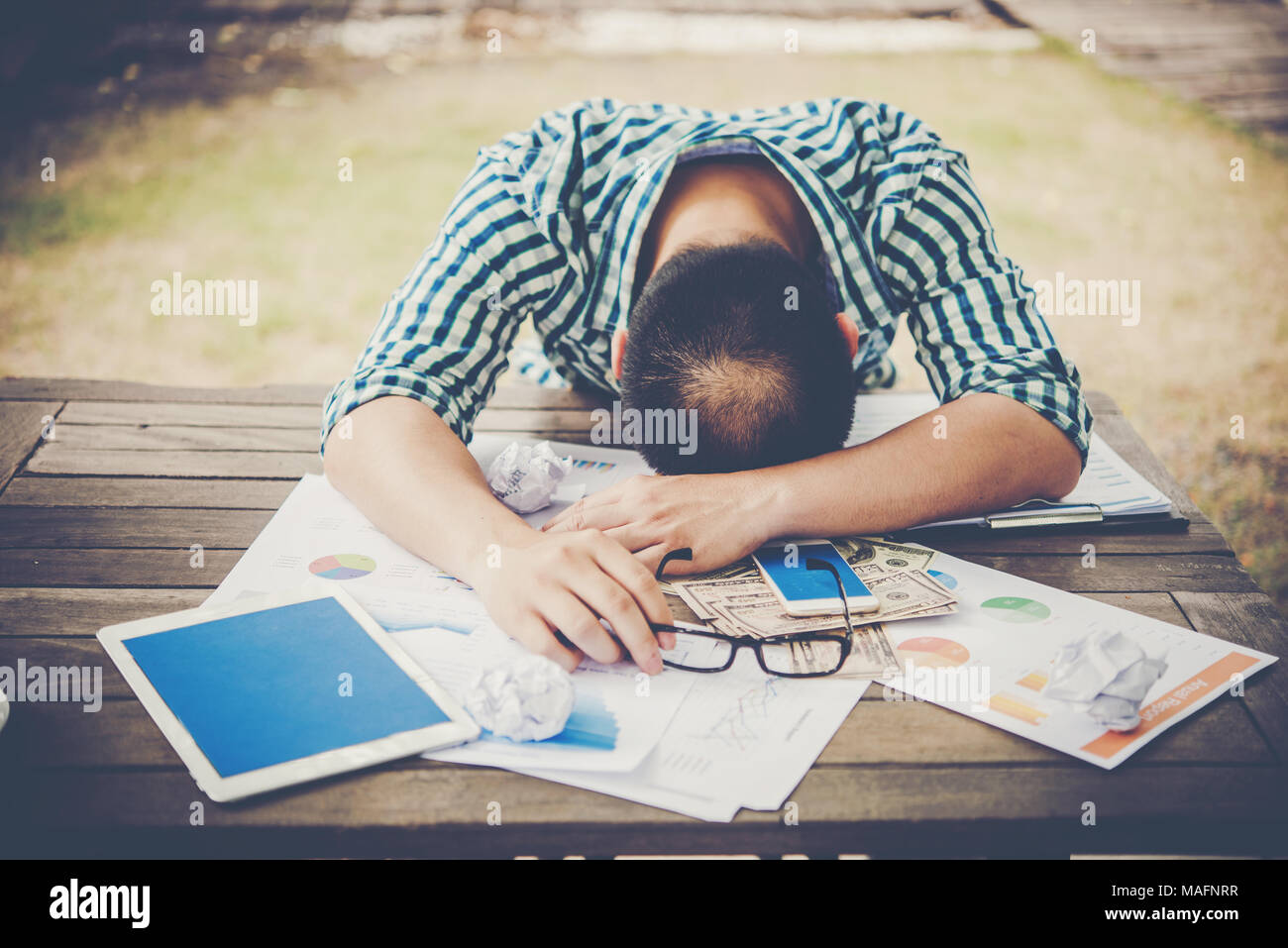 Tired working man sleeping at the workplace full of work Stock Photo ...